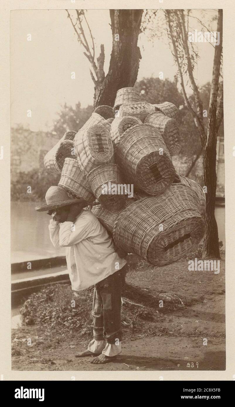 Man carrying baskets hi-res stock photography and images - Alamy