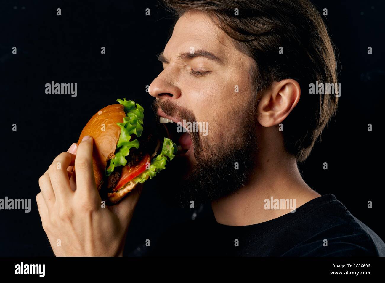 Man eating hamburger fast food restaurant diet Stock Photo - Alamy