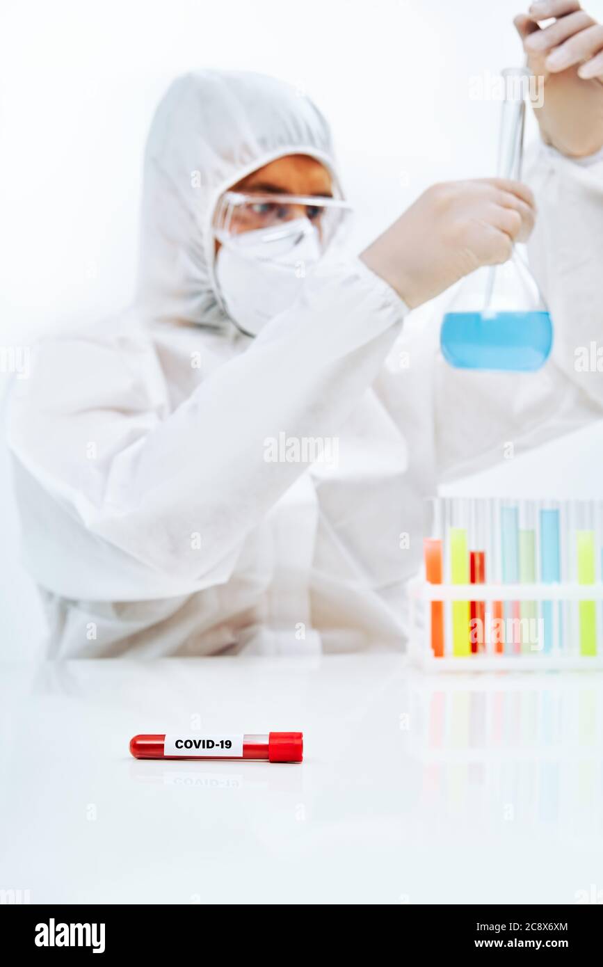 Scientist in PPE working in lab making microbiology research against ...