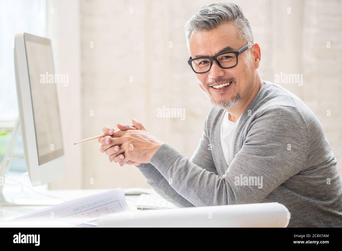 The indoor office senior designer portrait Stock Photo - Alamy