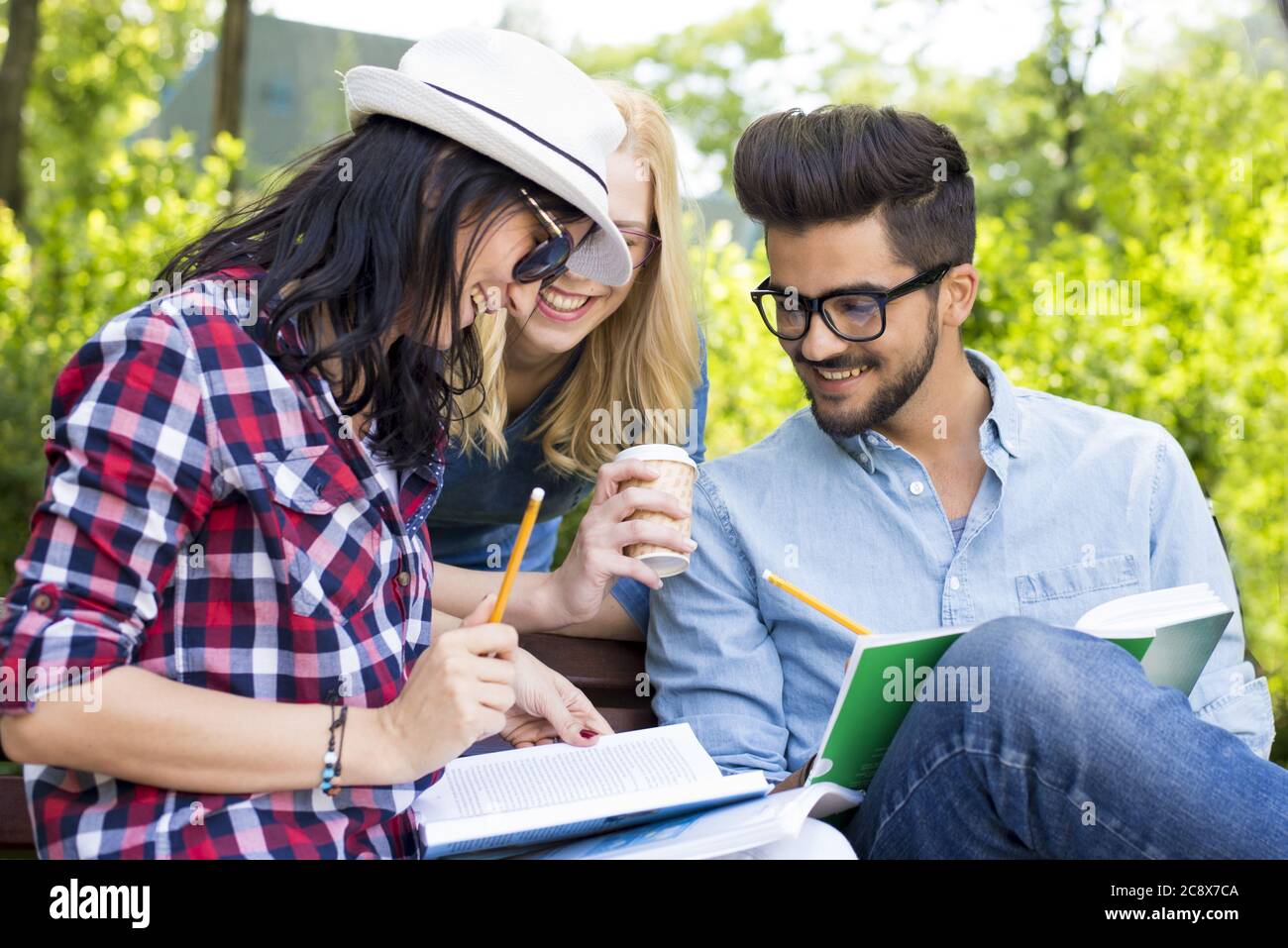 Group of young college students having fun while discussing homework on ...