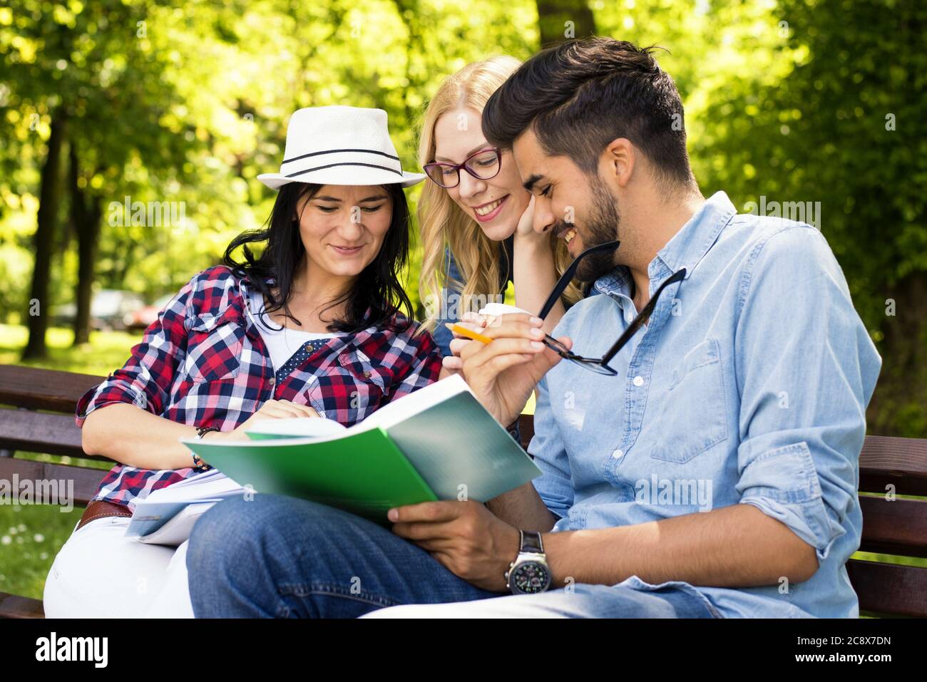 Group of young college students having fun while discussing homework on ...