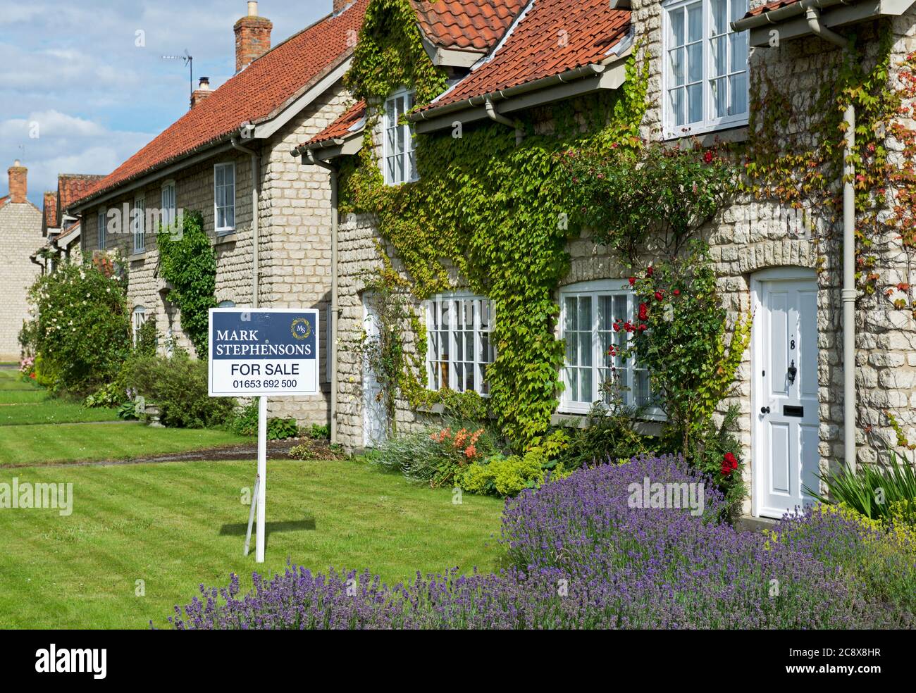 House for sale sign in the village of Hovingham, Ryedale, North ...