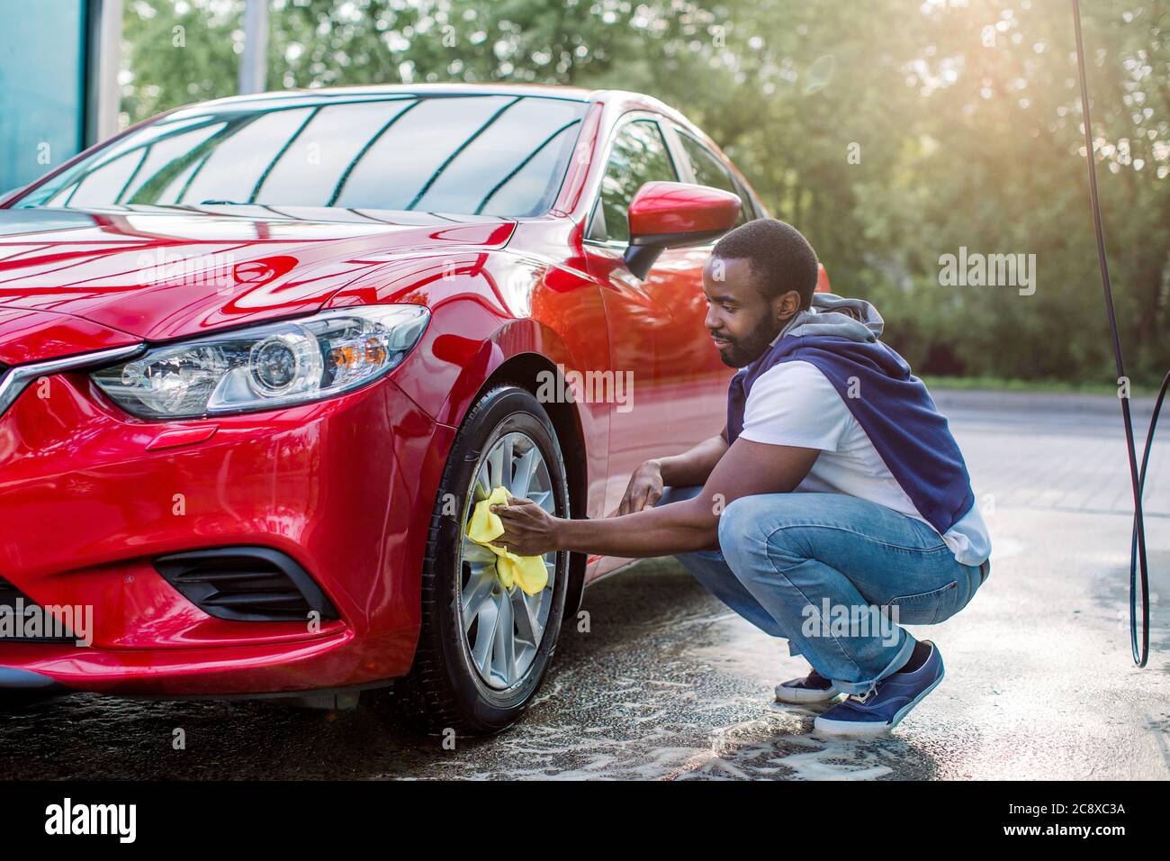 Car wash service outdoors. Car wash self-service concept. Handsome ...