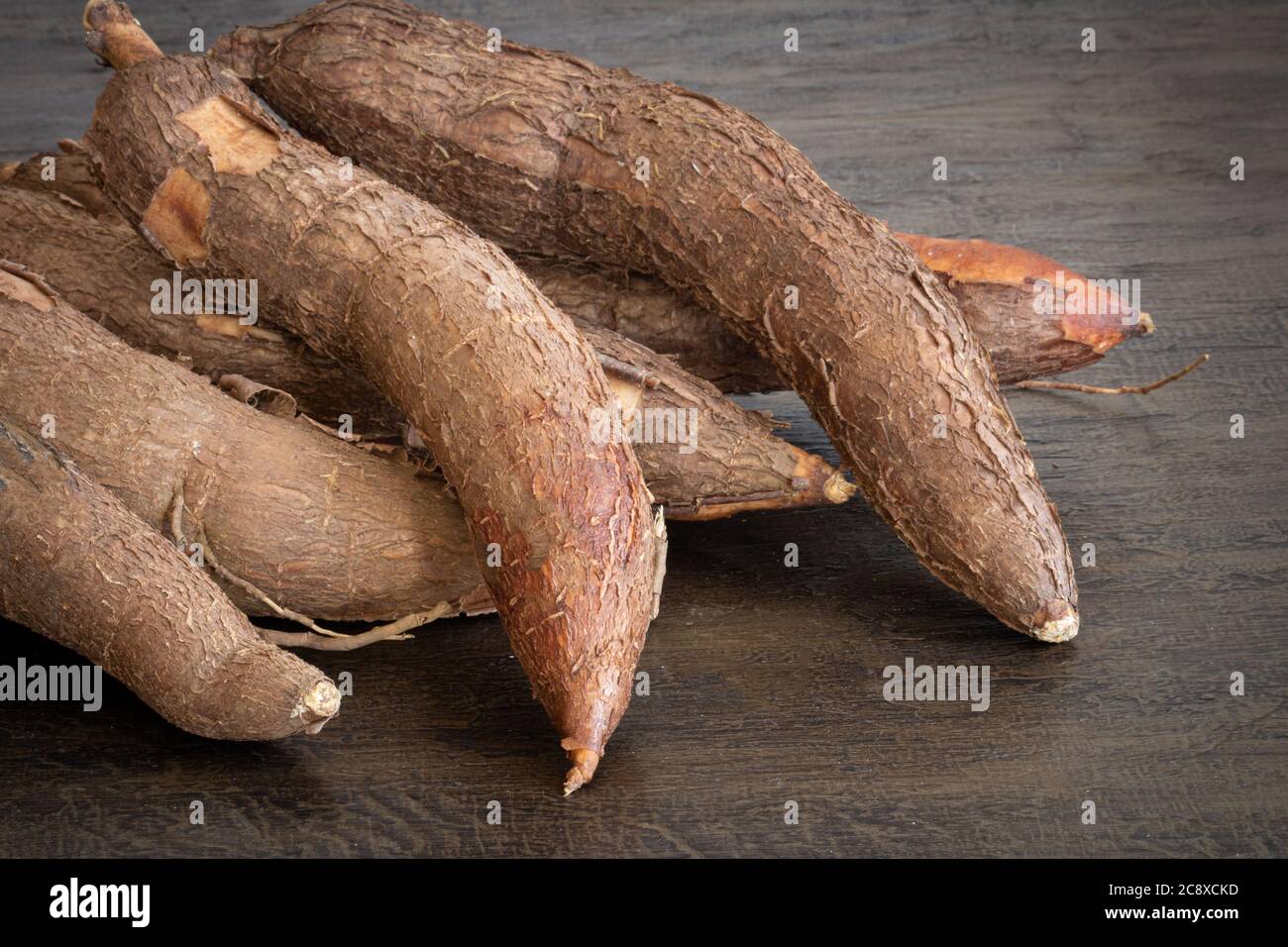 Fresh Cassava root with rustic wood background. Copy space Stock Photo ...