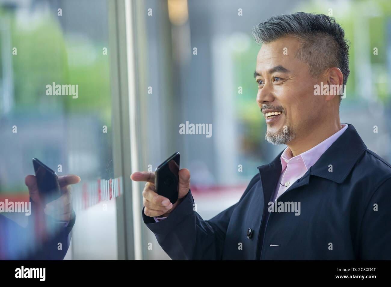 Business men watch window reflection of himself Stock Photo - Alamy