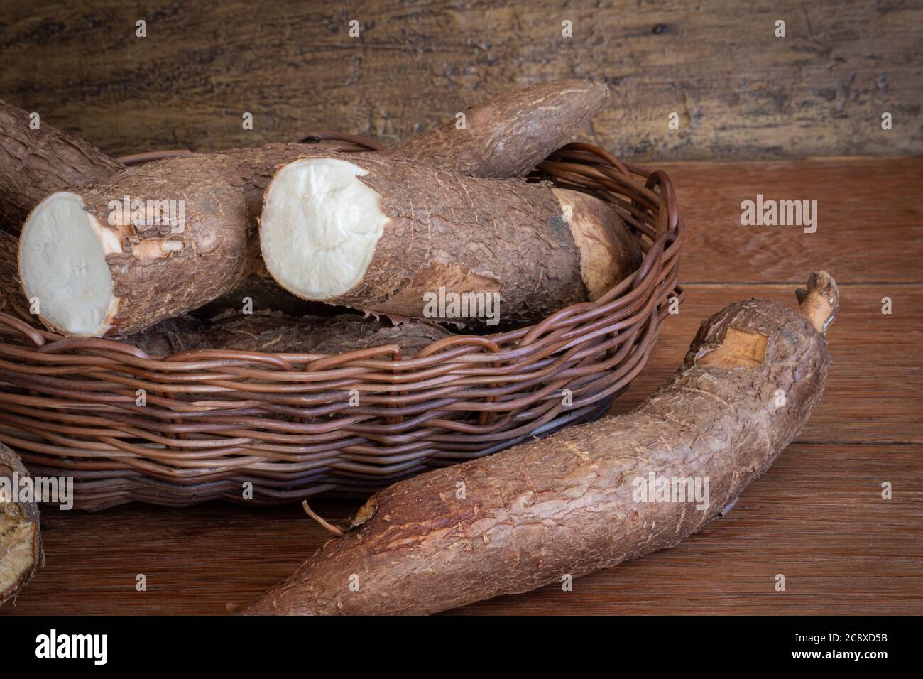 Fresh Cassava root on a wooden background. Copy space Stock Photo - Alamy