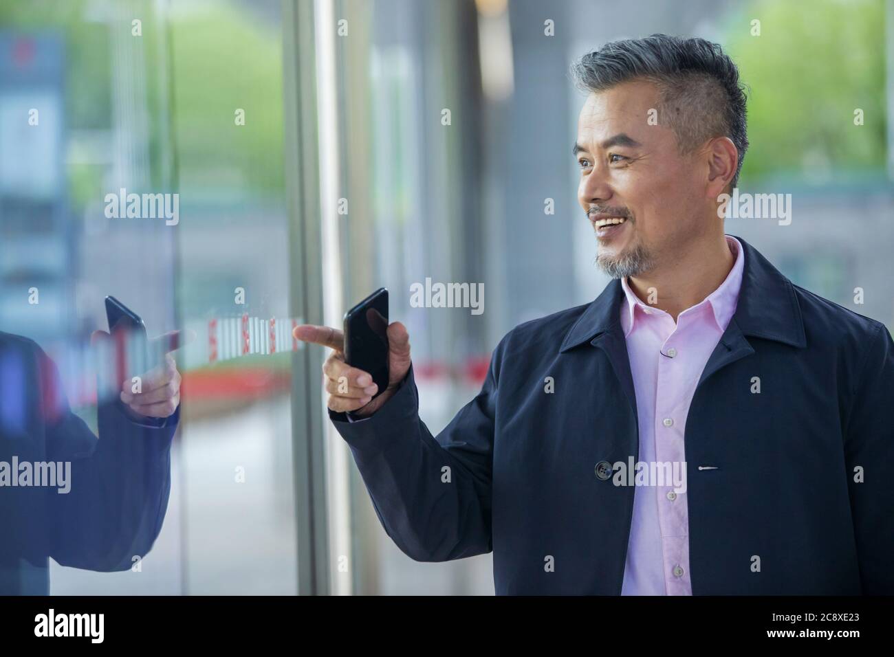 Business men watch window reflection of himself Stock Photo - Alamy