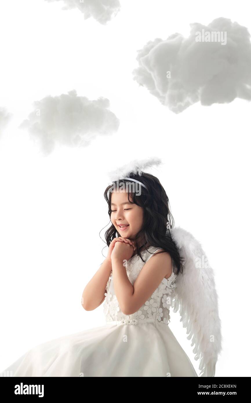Happy little angel praying Stock Photo - Alamy