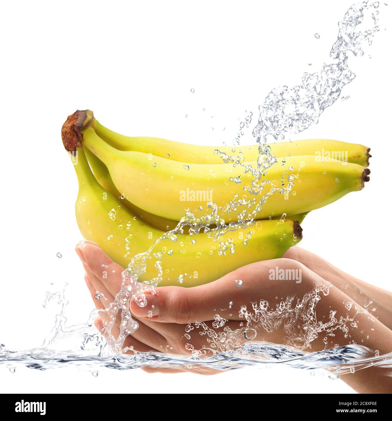 fresh bananas falling in water Stock Photo - Alamy