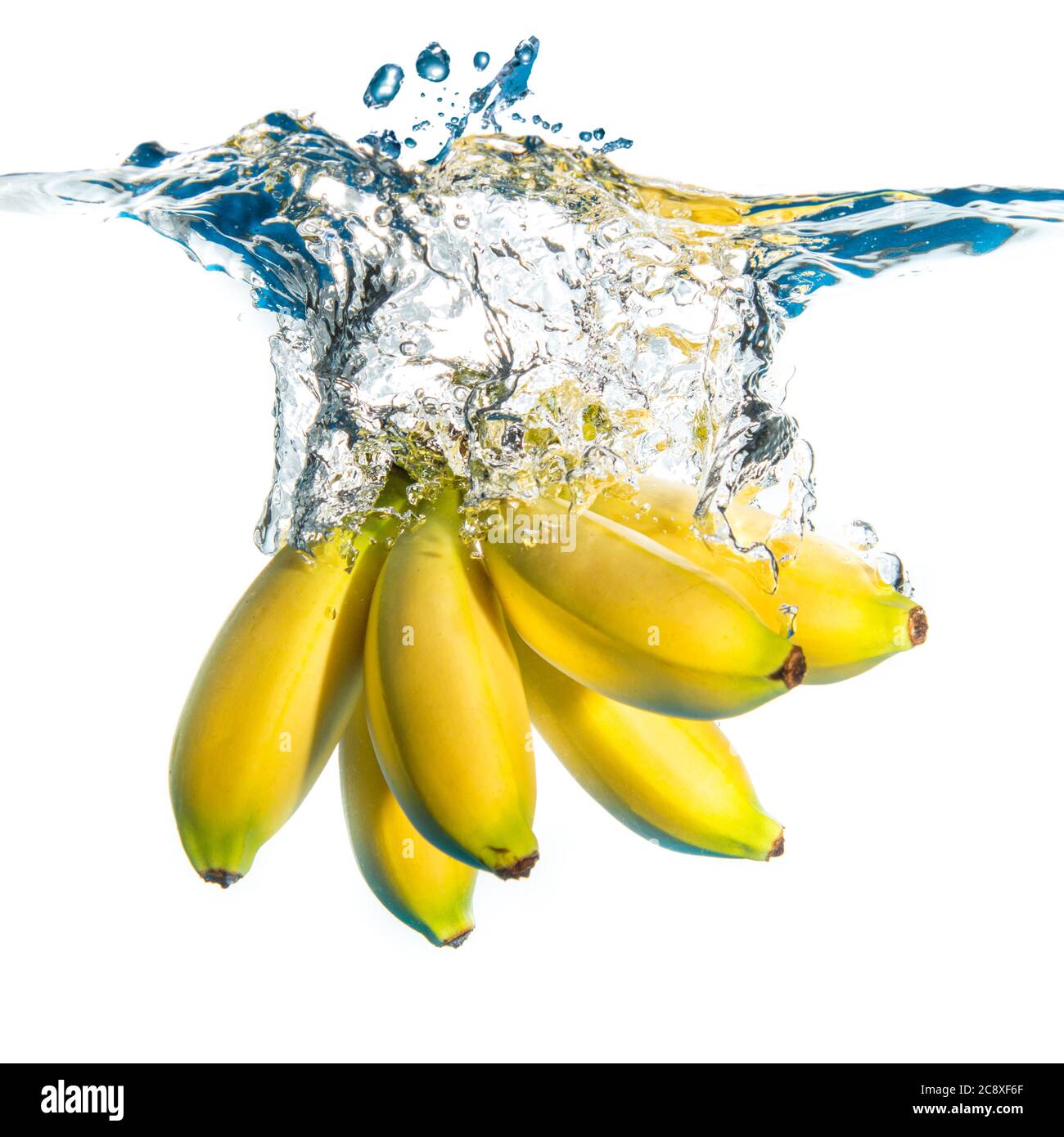 fresh bananas falling in water Stock Photo - Alamy
