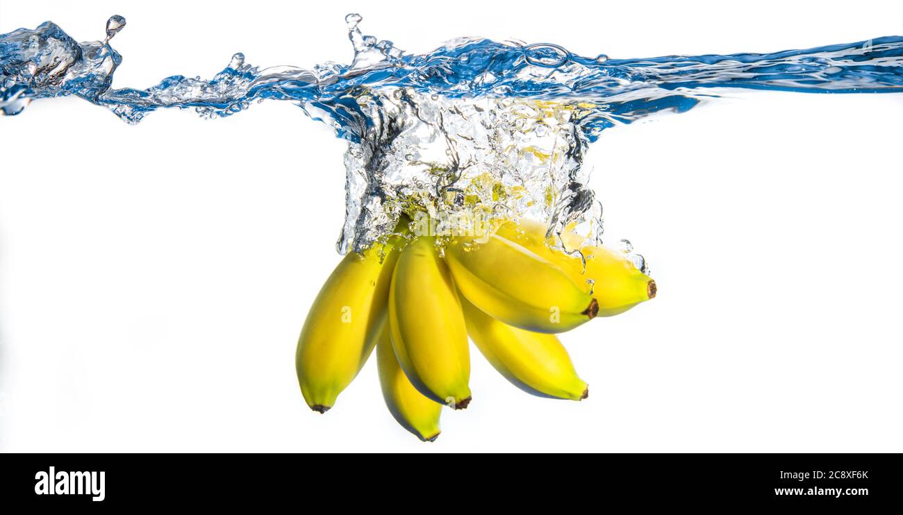 fresh bananas falling in water Stock Photo - Alamy