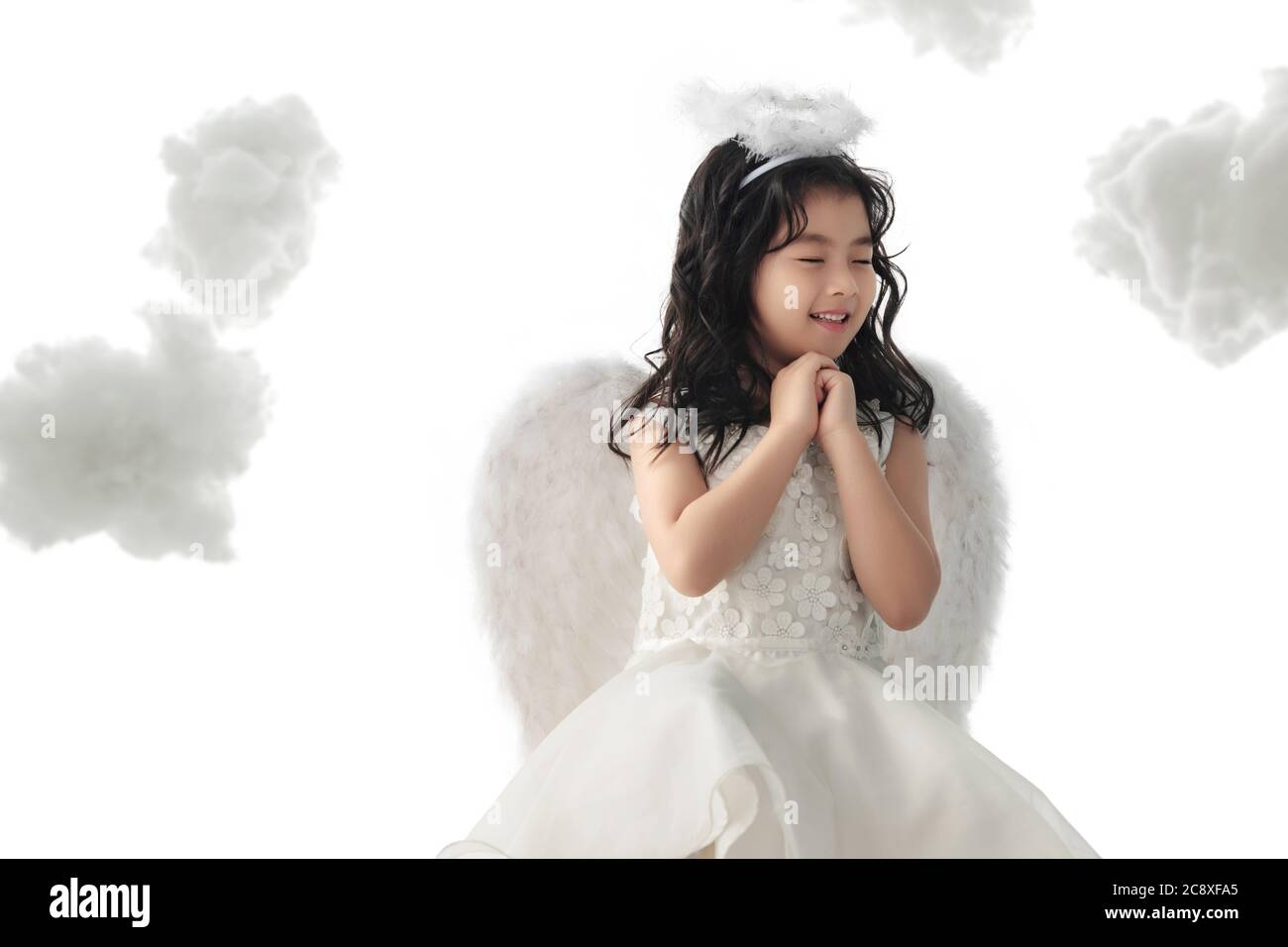 Happy little angel praying Stock Photo - Alamy
