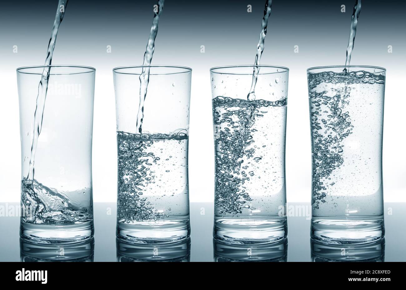 Water filling four glasses in sequence Stock Photo - Alamy