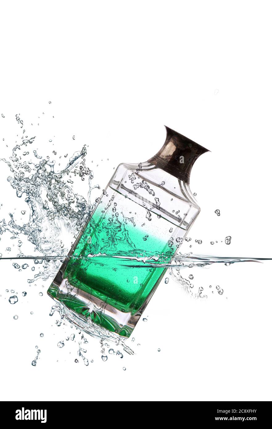 green glass bottle falling in water Stock Photo - Alamy