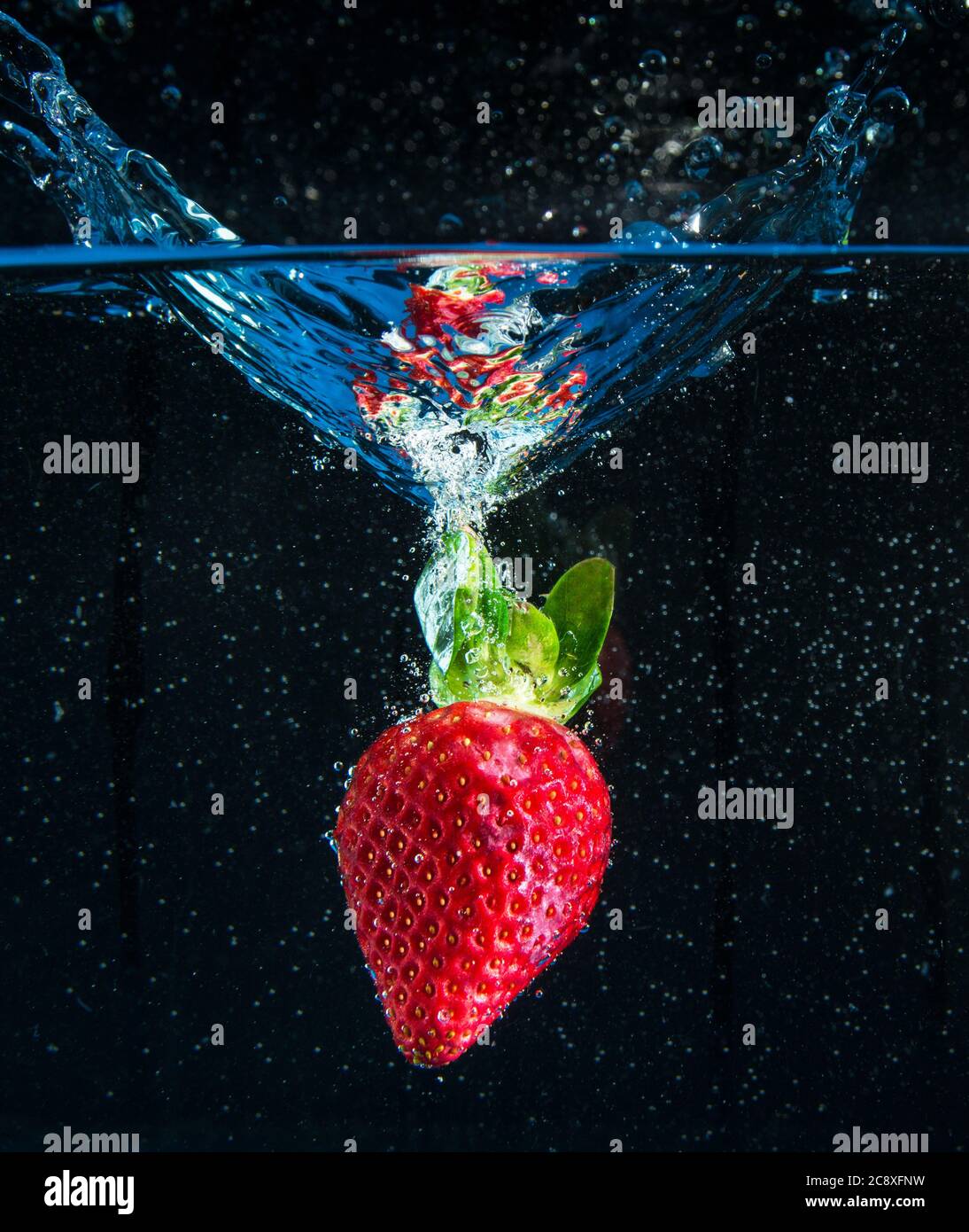 fresh strawberry falling in water Stock Photo - Alamy