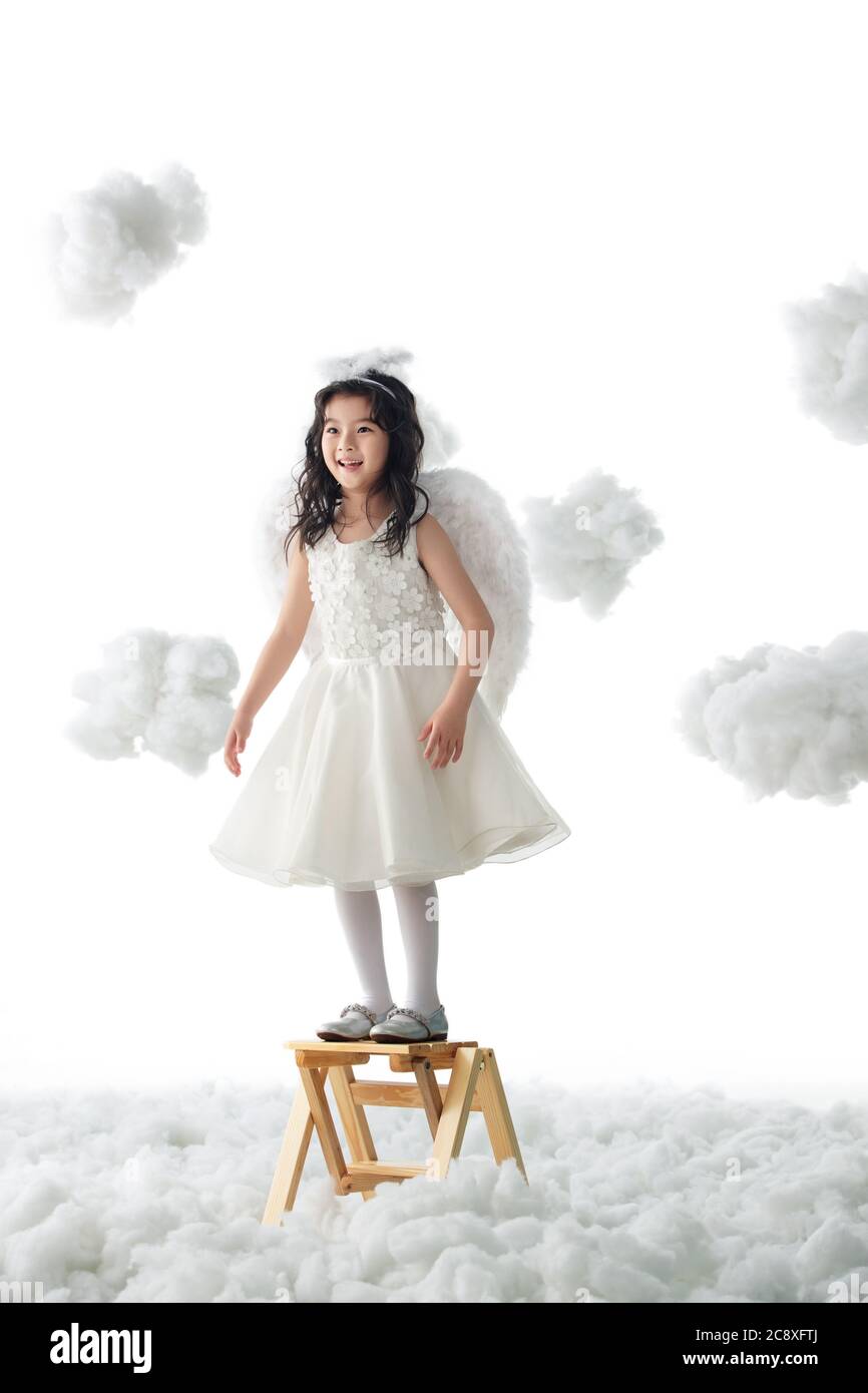 The little angel standing on a ladder Stock Photo - Alamy