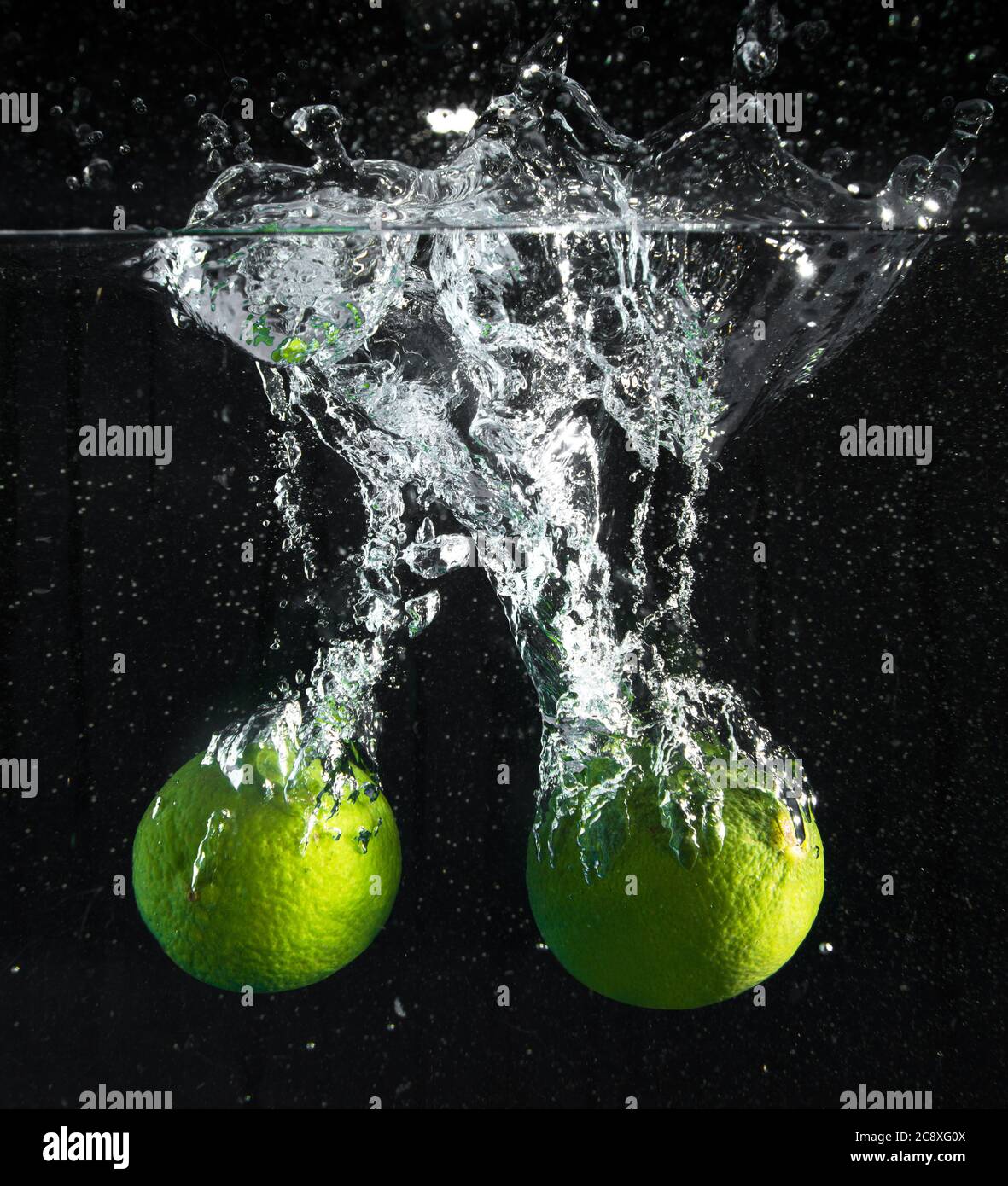 fresh lime falling in water Stock Photo - Alamy