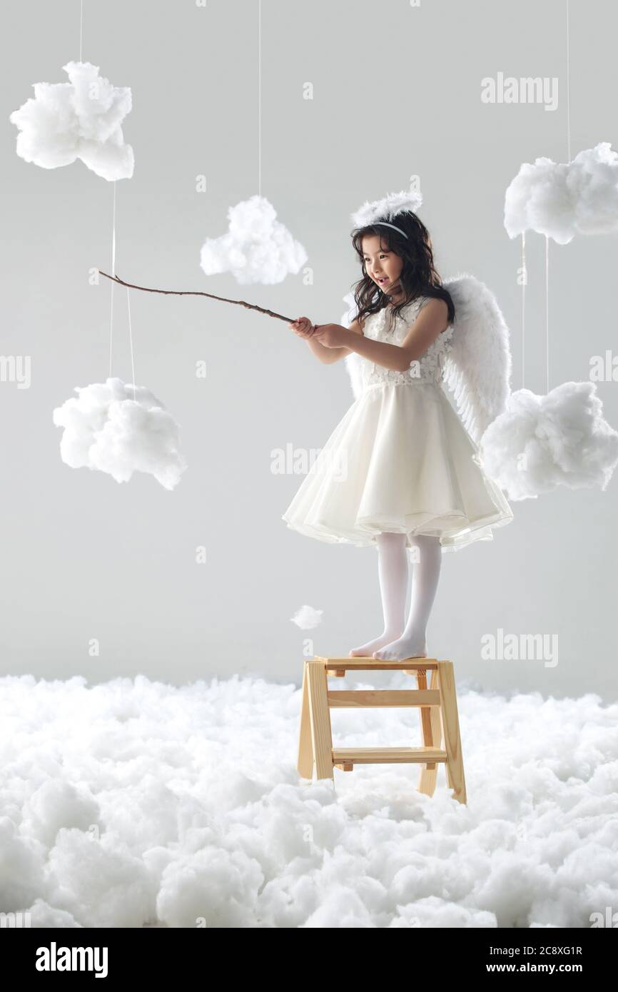 Happy little girl standing on the ladder Stock Photo - Alamy