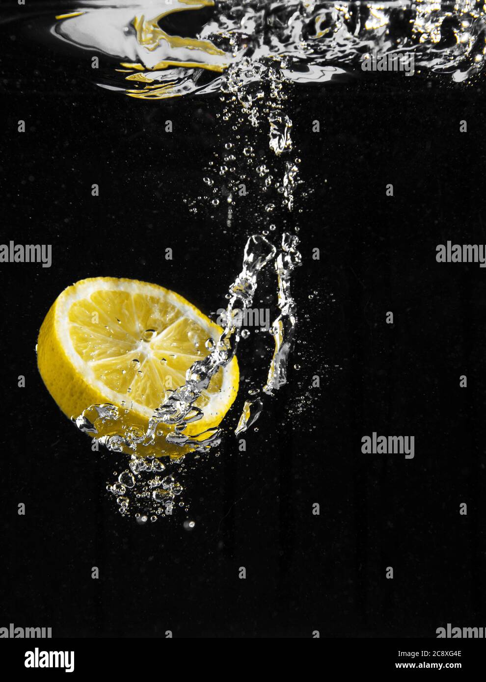 fresh lemon falling in water Stock Photo - Alamy