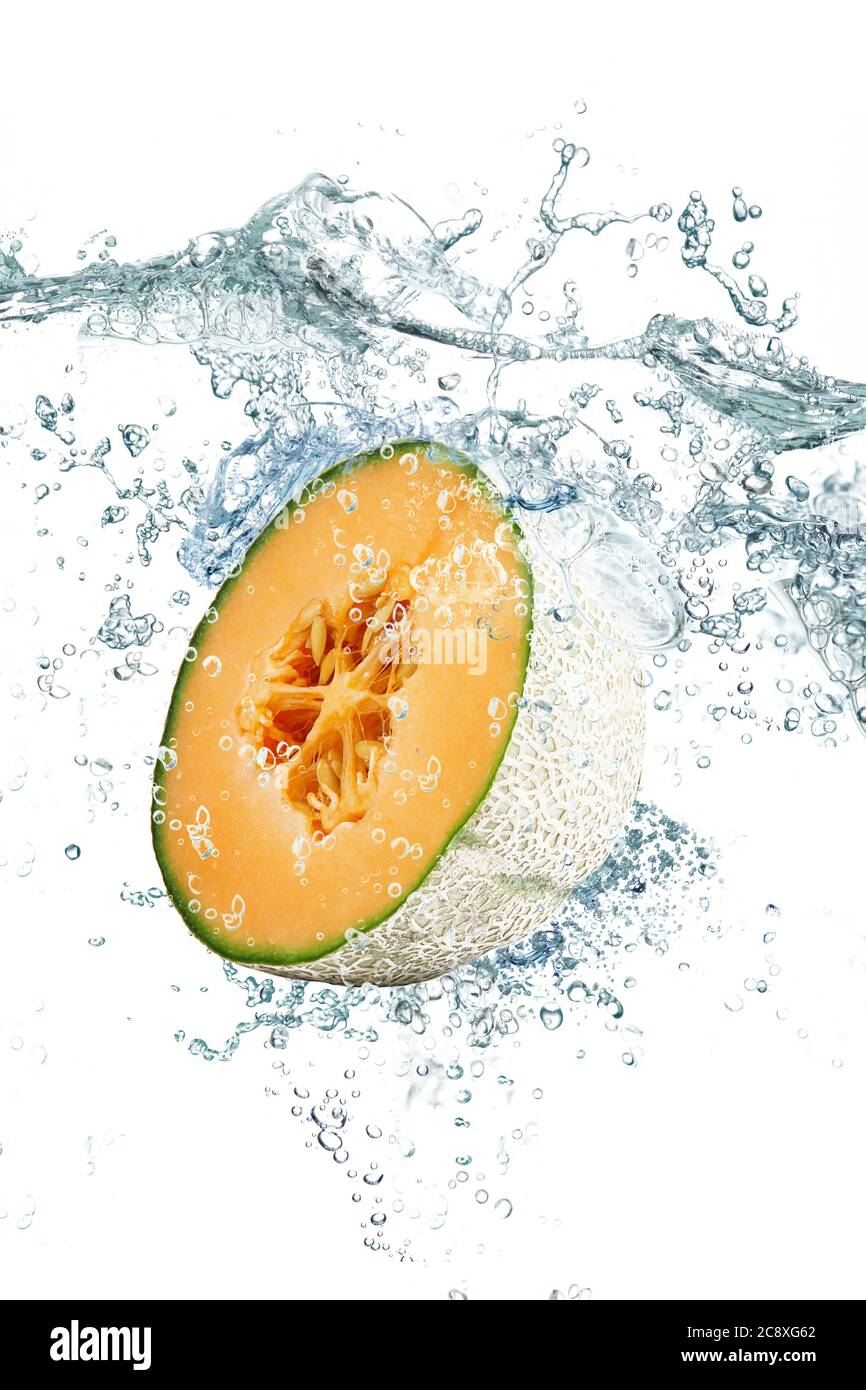 fresh melon falling in water Stock Photo - Alamy
