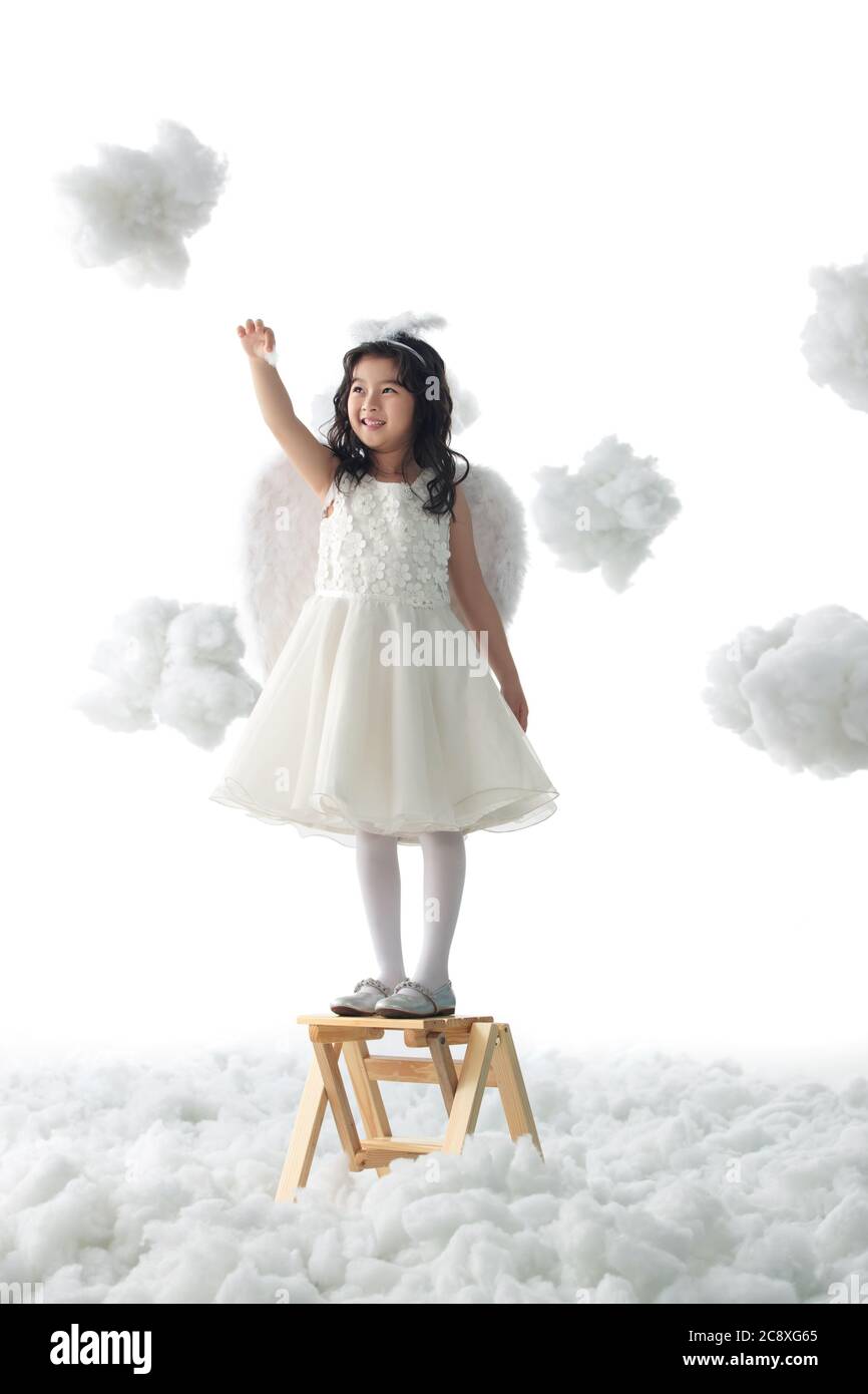 Standing on a ladder play little angel Stock Photo - Alamy