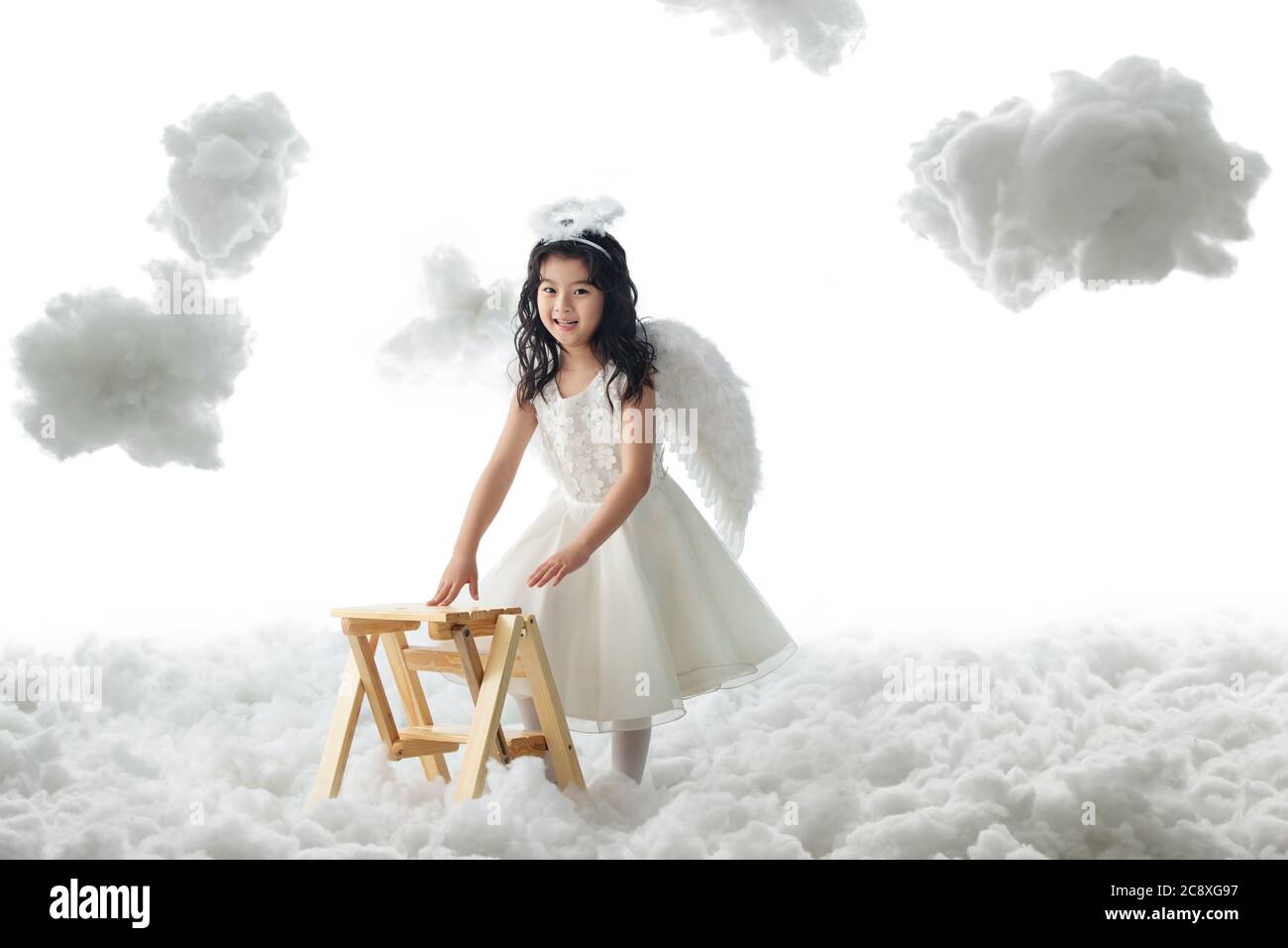 The little angel standing on a ladder Stock Photo - Alamy