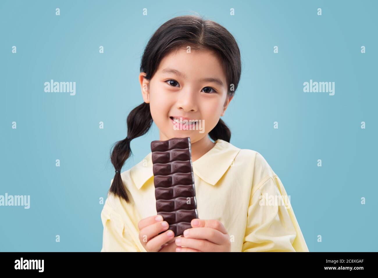 Eat chocolate girl Stock Photo - Alamy