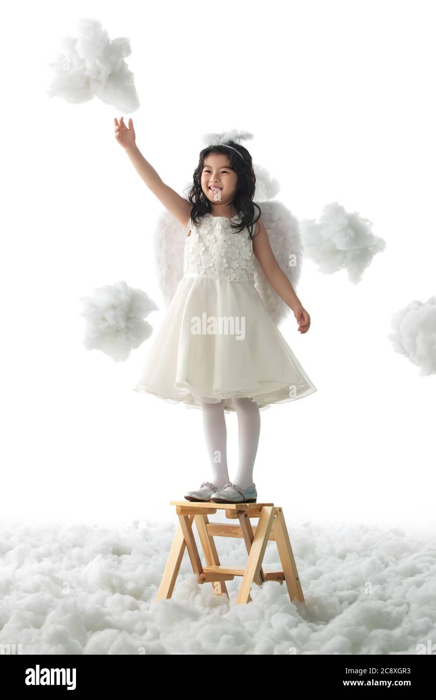 Standing on a ladder play little angel Stock Photo - Alamy