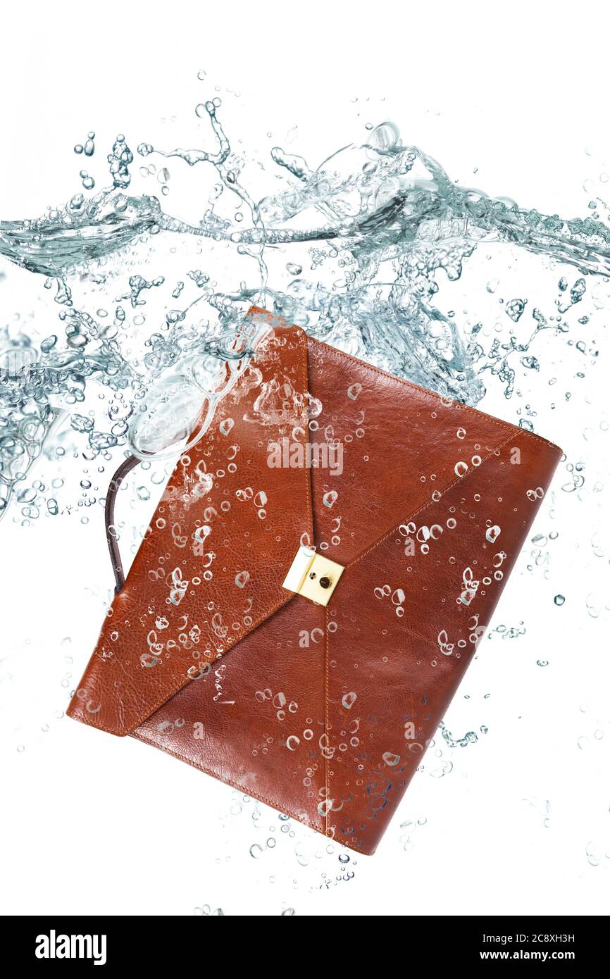 little suitcase falling in water Stock Photo - Alamy