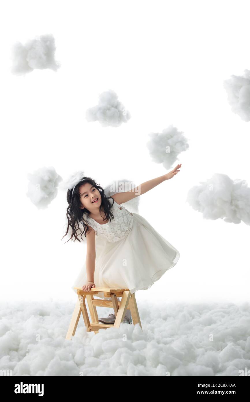 Standing on a ladder play little angel Stock Photo - Alamy