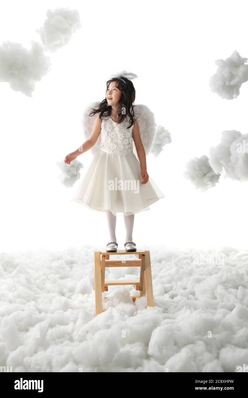 Standing on a ladder play little angel Stock Photo - Alamy