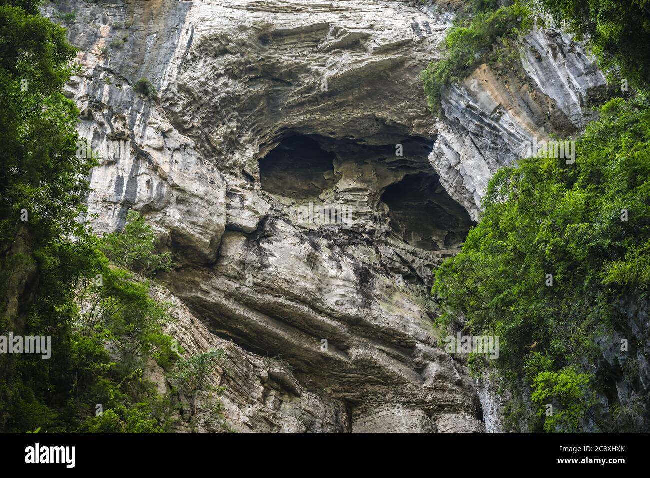 Cliffside holes and fissures resembling human eyes, nose and mouth and ...