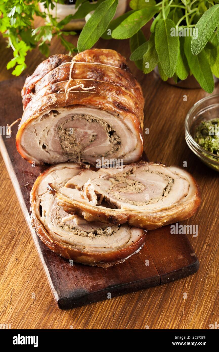 Traditional italian porchetta. Rolled pork belly stuffed with mincemeat ...