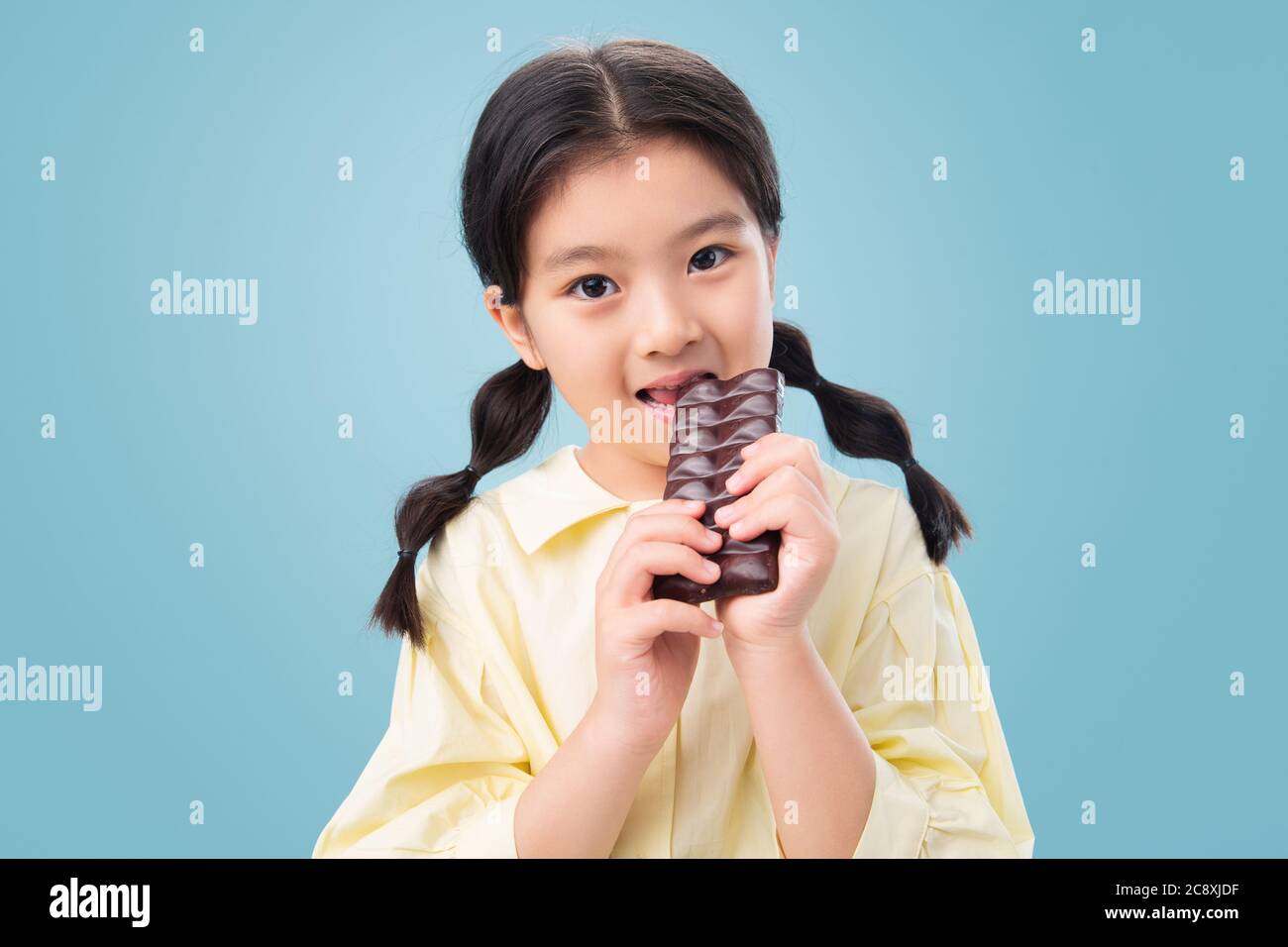 Eat chocolate girl Stock Photo - Alamy