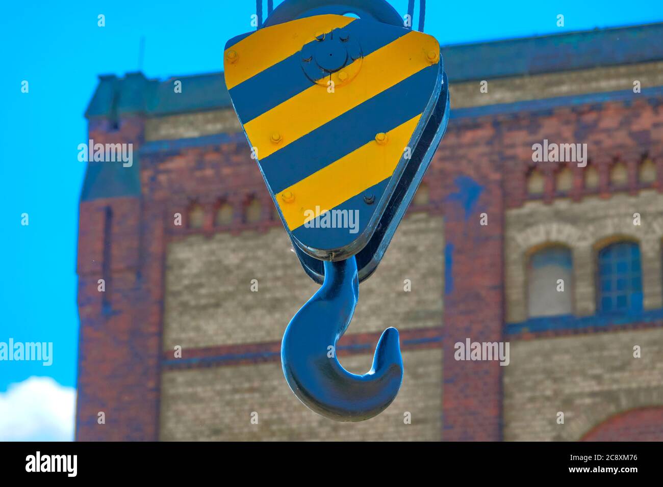 Heavy duty iron hook in a black and yellow fixation in front of an ...