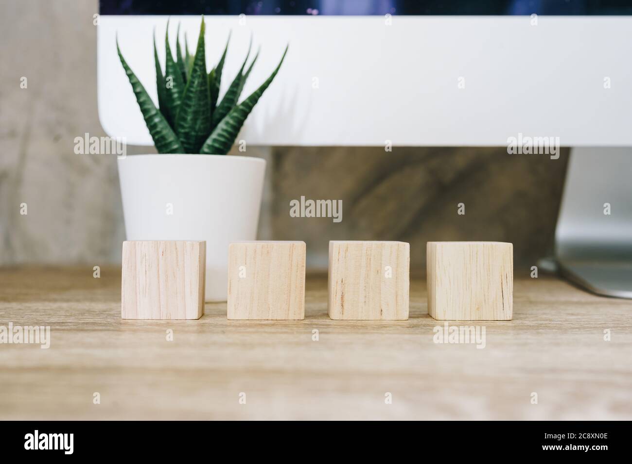 Four wooden toy cubes on wooden table background with copy space Stock ...