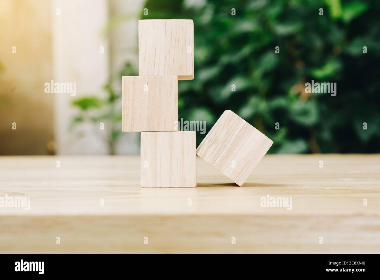 Four wooden toy cubes on wooden table background with copy space Stock ...