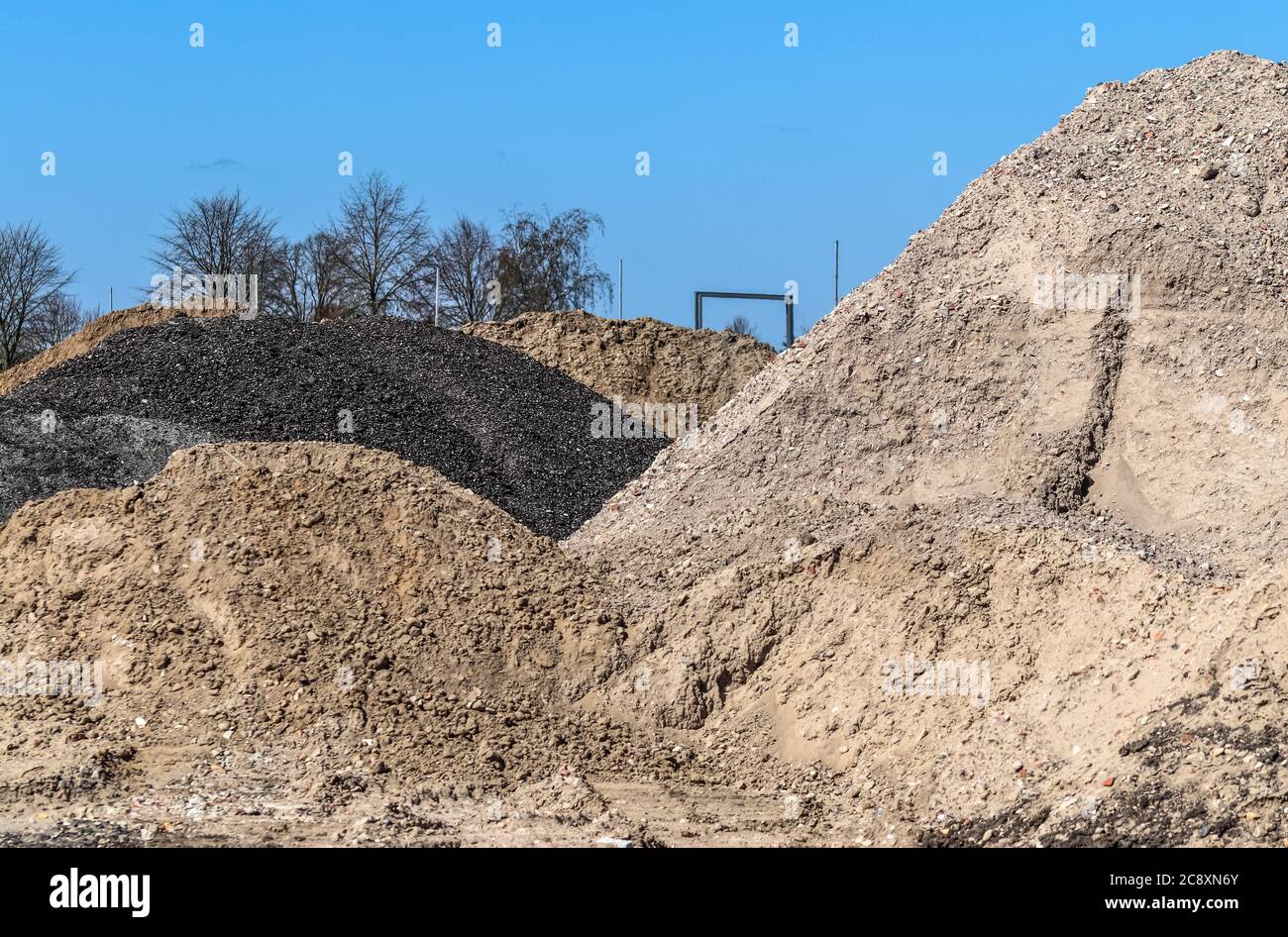 View into a gravel pit with piles of sand and tire tracks Stock Photo ...