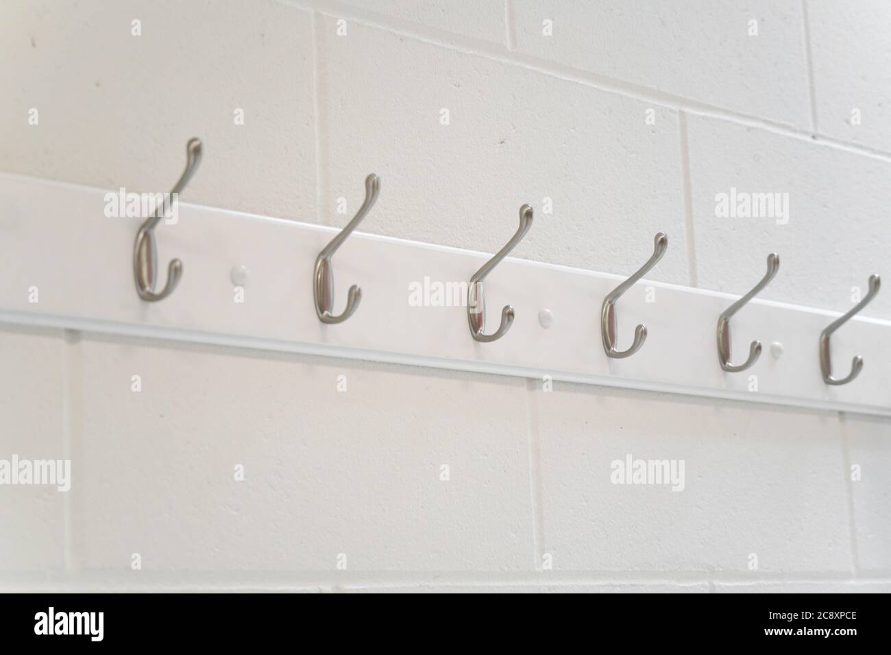 Row of hooks hi-res stock photography and images - Alamy