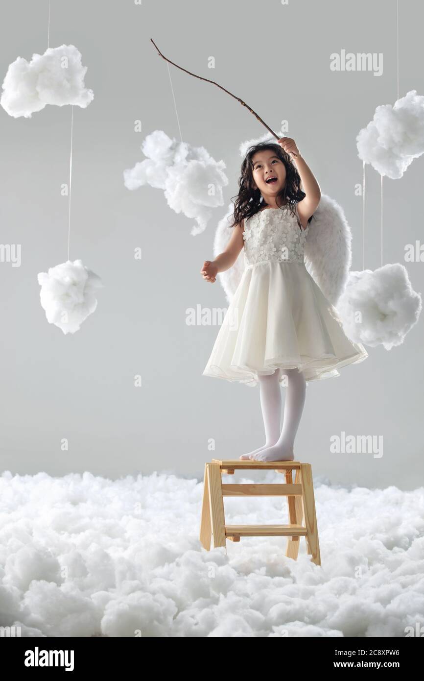 Happy little girl standing on the ladder Stock Photo - Alamy