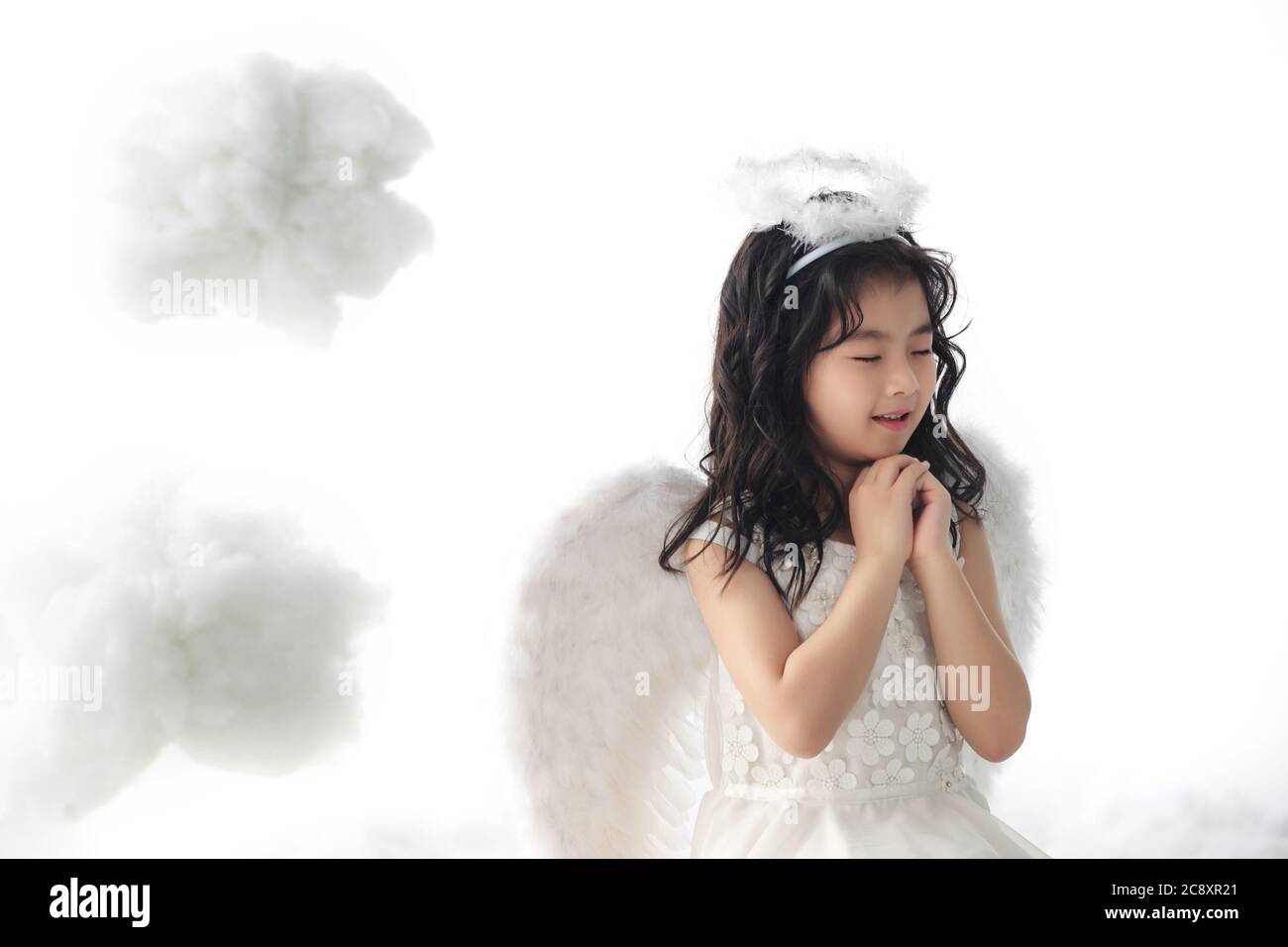 Happy little angel praying Stock Photo - Alamy
