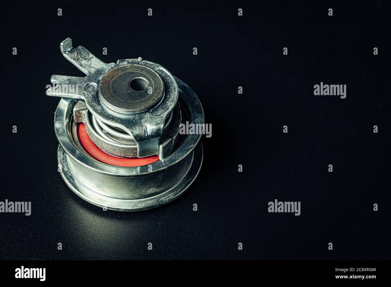 Metal car engine spare part on black background Stock Photo - Alamy