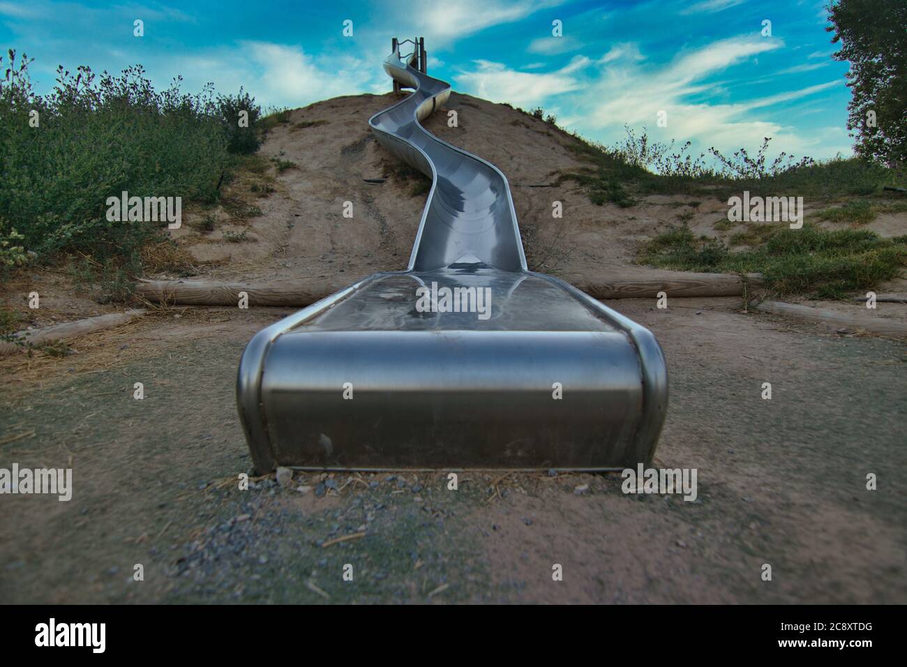 giant slide with blue sky and some kids playing Stock Photo - Alamy