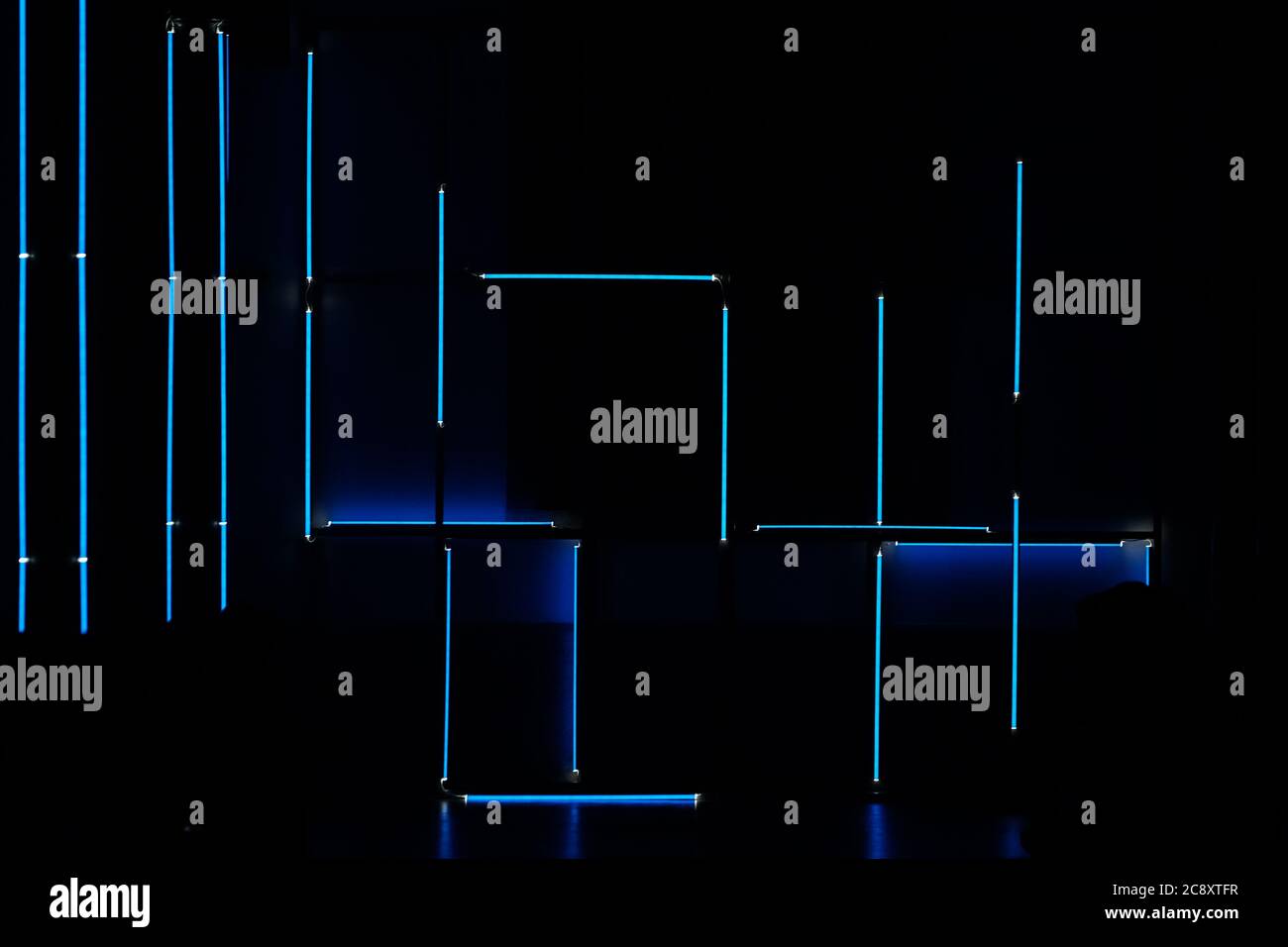 Cool blue neon lights on a black wall Stock Photo - Alamy