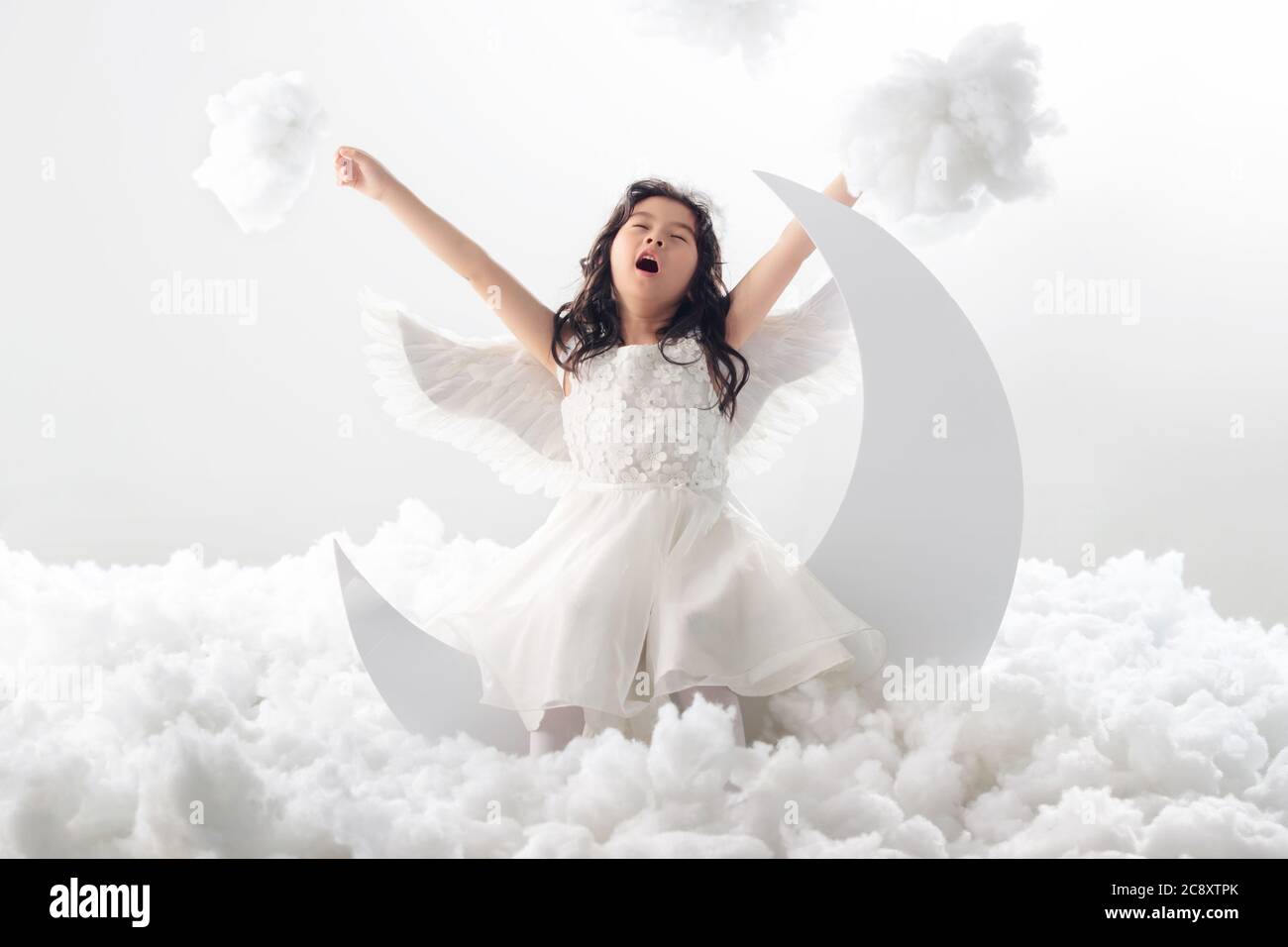 Angel sat down on the moon yawn Stock Photo - Alamy