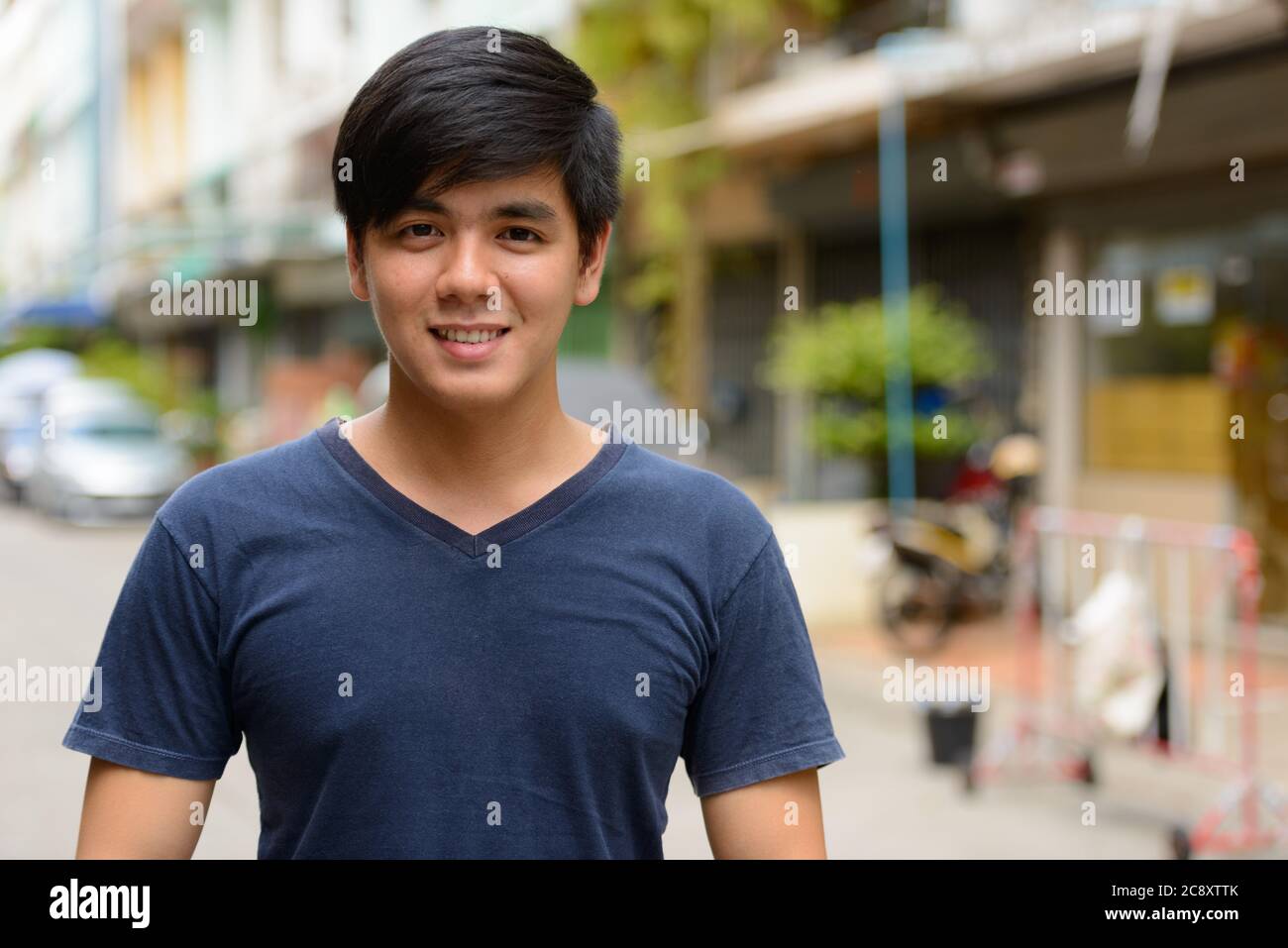 Portrait of young handsome Asian man outdoors Stock Photo - Alamy