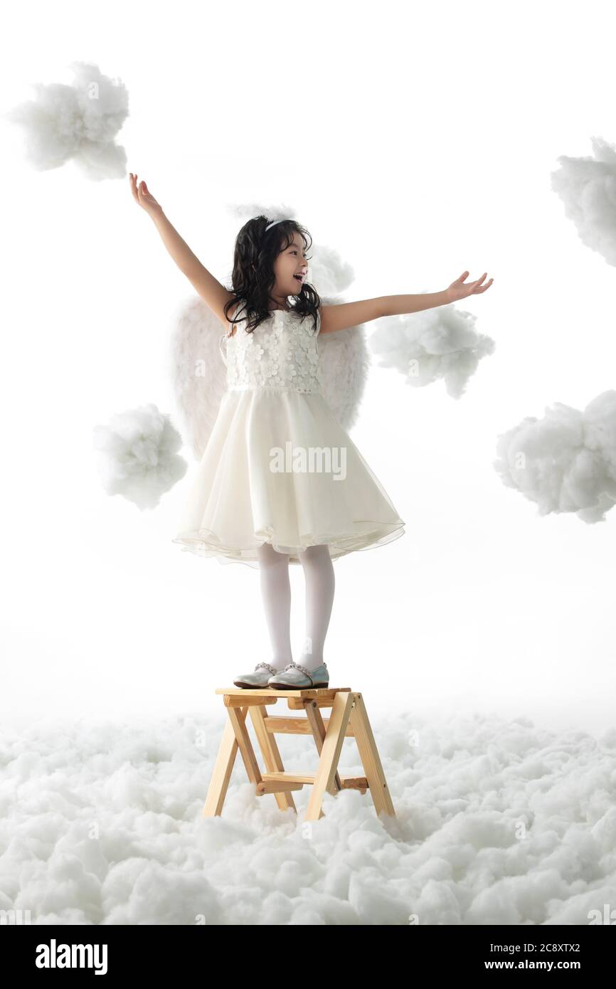 Standing on a ladder play little angel Stock Photo - Alamy
