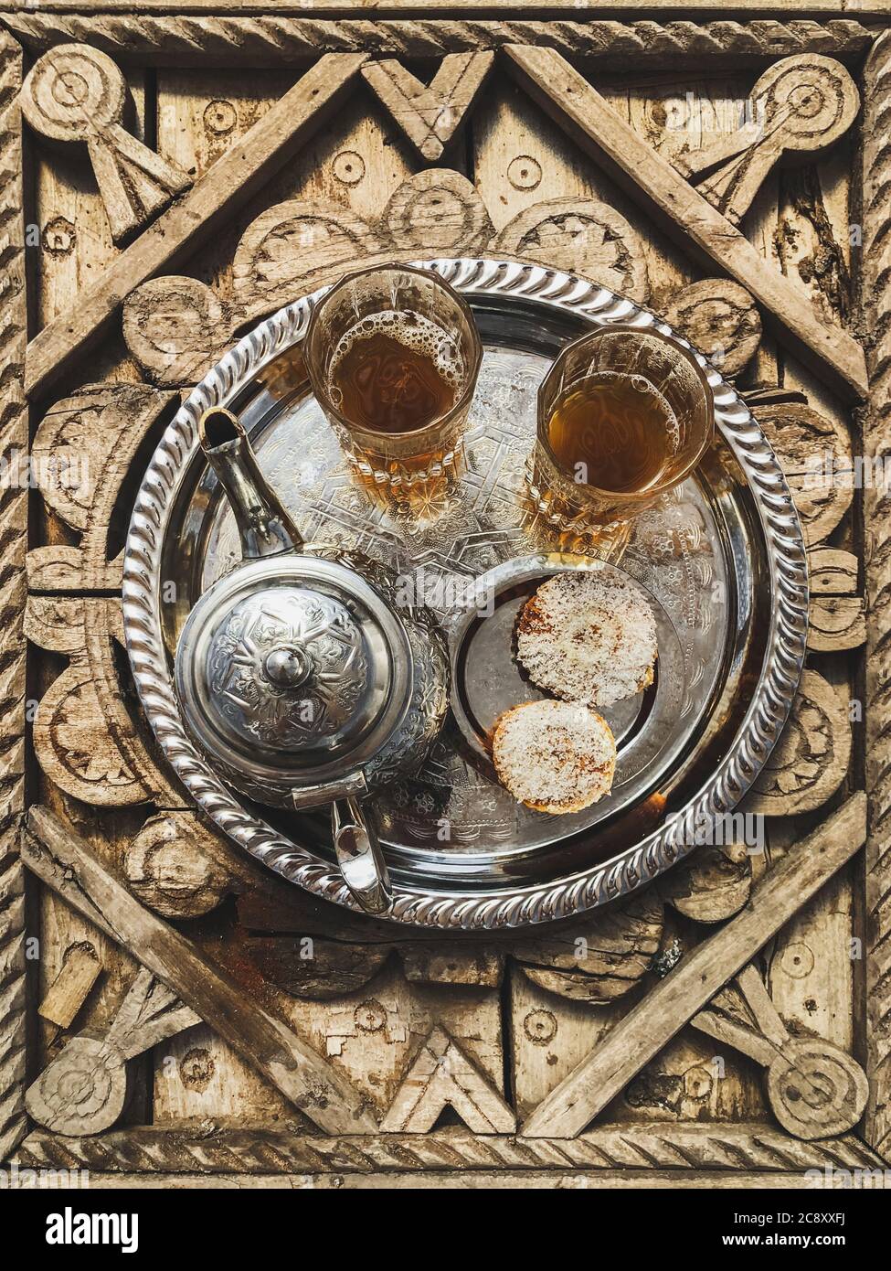 Traditional moroccan mint tea with cookies on silver tray on carved ...