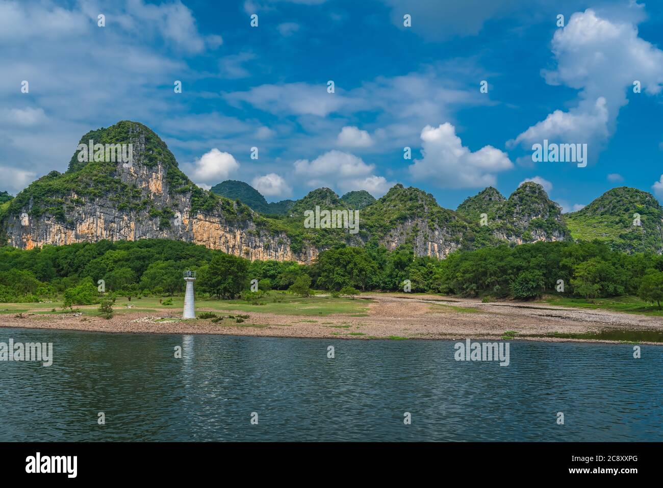 Panoramic view of the stunning karst mountain scenery on the riverbank ...
